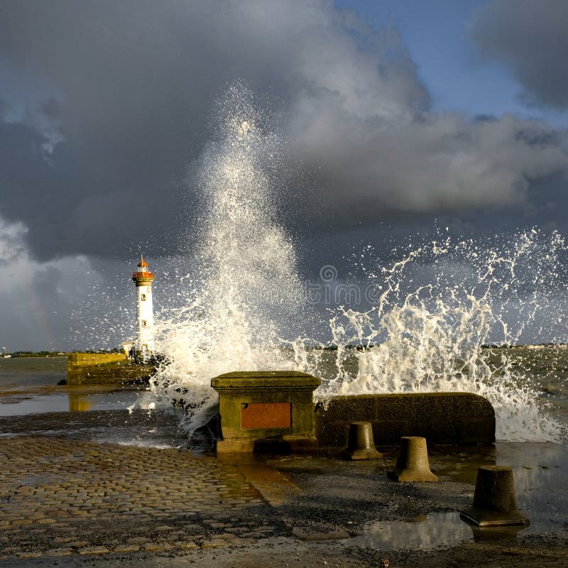 Fresh Splash of Water Next To a Lighthouse Under the Gloomy Sky Stock ...