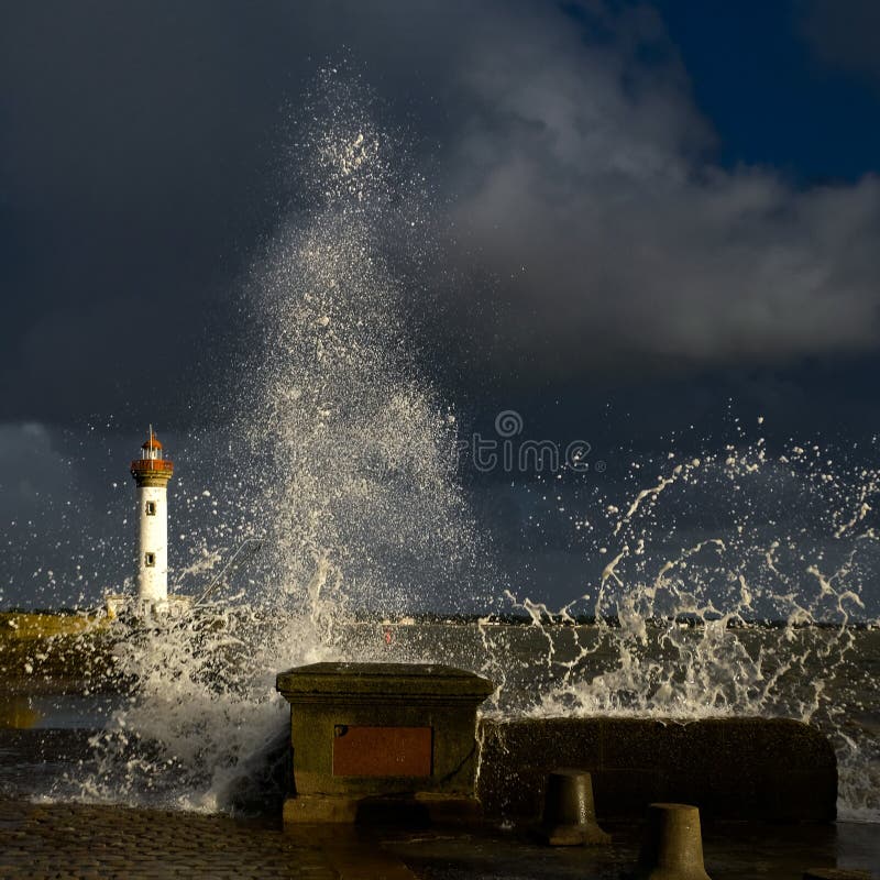 Fresh Splash of Water Next To a Lighthouse Under the Gloomy Sky Stock ...