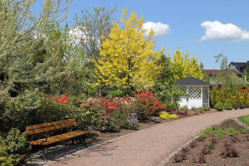 Fresh spring garden. stock photo. Image of flowers, bench - 83716442