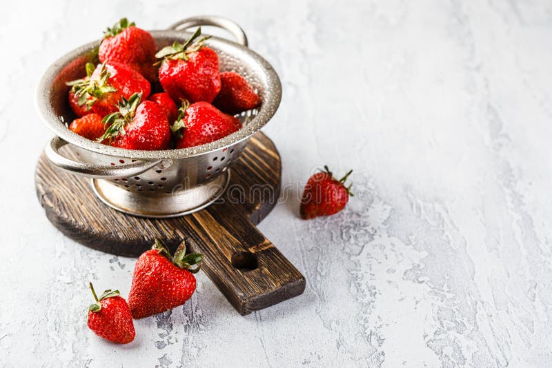 Red Strawberries in Colander on a White Wooden Table Stock Image ...