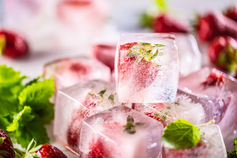 Fresh Strawberries Frozen in Ice Blocks with Melissa Leaves Stock Image ...