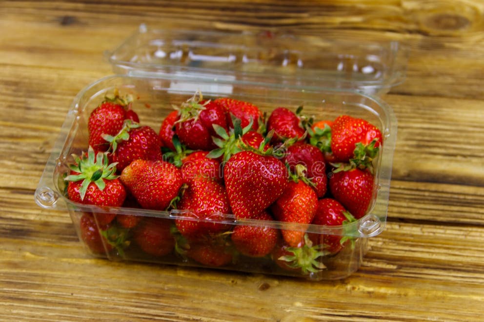 Fresh Strawberry in Plastic Box on Wooden Table Stock Photo - Image of ...