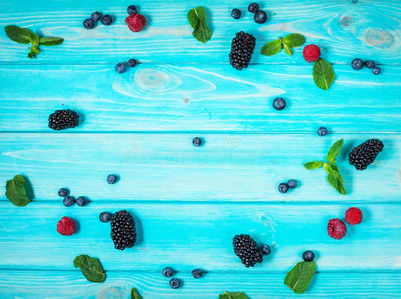Fresh Summer Berries, Corner Frames on Blue Wooden Background Stock ...
