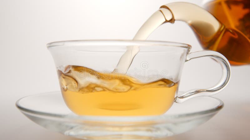 Fresh Tea Flows in a Tea Cup from a Teapot Stock Image - Image of flow ...