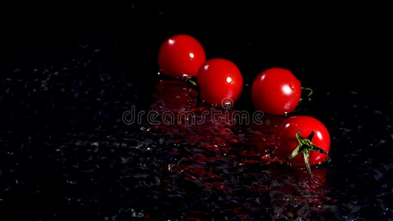 Tomatoes Falling into the Water with a Splash and Bubbles on Black ...