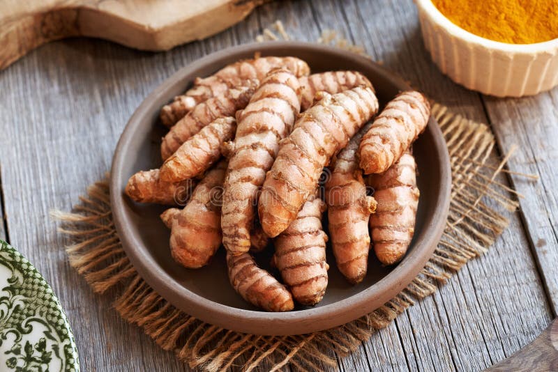 Fresh Turmeric Root with Curcuma Powder in the Background Stock Photo ...