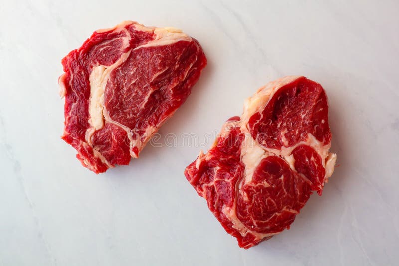 Fresh Uncooked Beef Steaks on Light Background Stock Photo - Image of ...