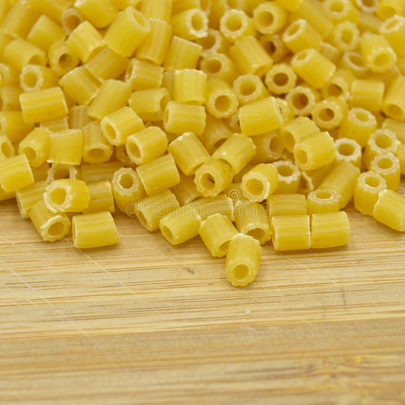 Fresh Uncooked Gold Colored Pasta, on Bamboo Cutting Board Stock Image ...