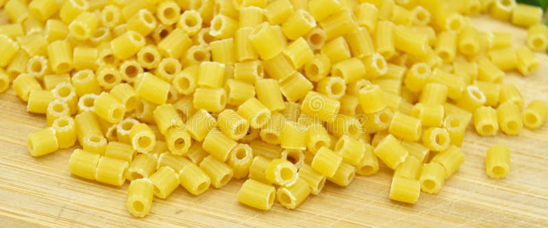 Fresh Uncooked Gold Colored Pasta, on Bamboo Cutting Board Stock Photo ...