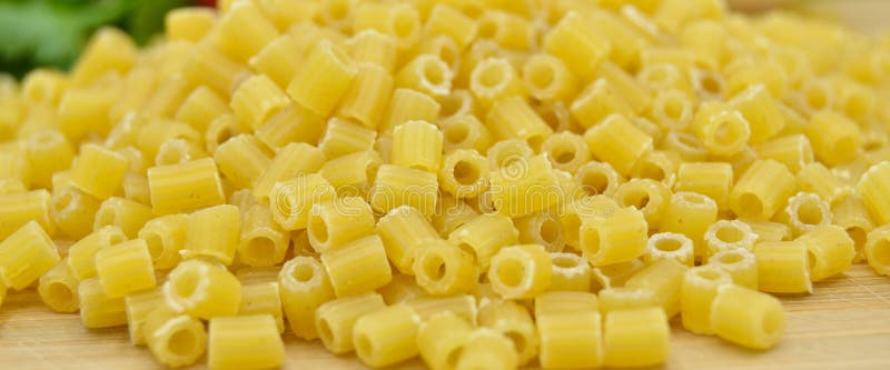 Fresh Uncooked Gold Colored Pasta, on Bamboo Cutting Board Stock Photo ...