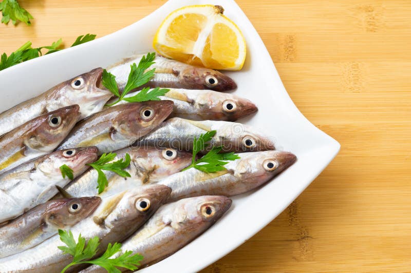 Fresh Uncooked Haddock Fishes on in Ceramic Dish on Table Stock Image ...