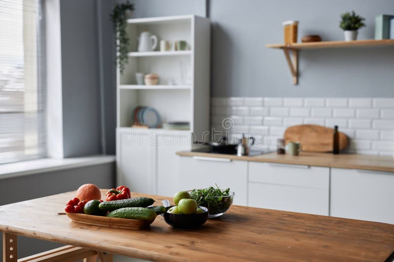 Fresh Vegetables Ready for Cooking on Wooden Table in Kitchen Interior ...