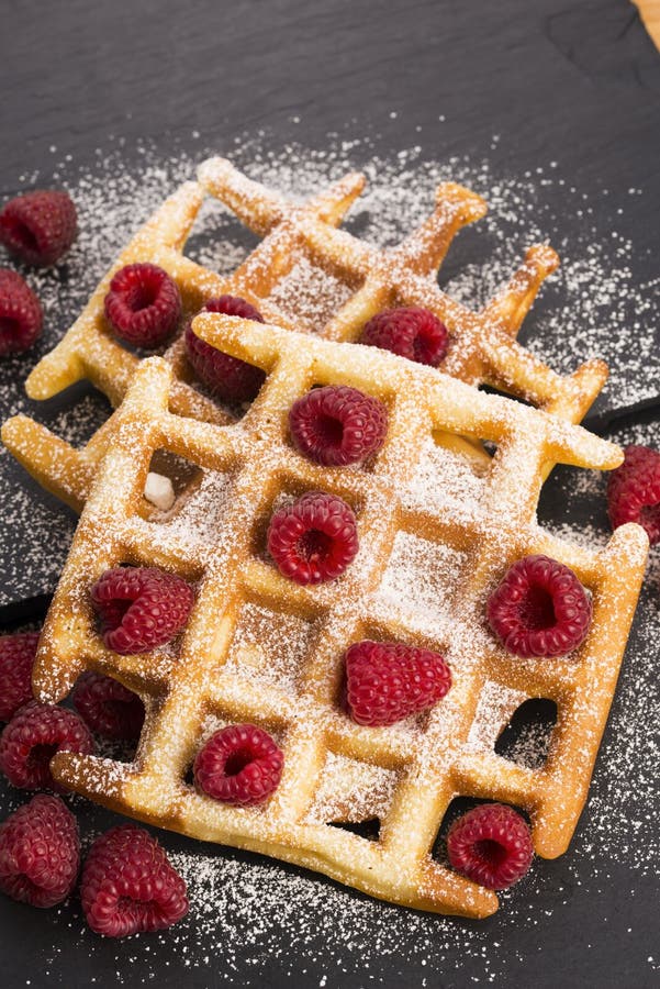 Fresh Waffles Garnished with Powdered Sugar and Raspberries Stock Image ...