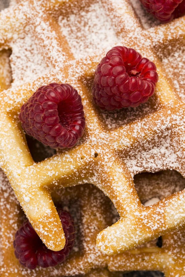 Fresh Waffles Garnished with Powdered Sugar and Raspberries Stock Photo ...