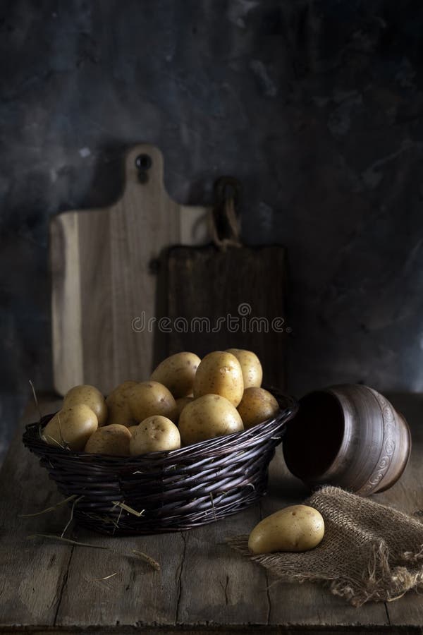 Fresh Washed Potatoes in a Wicker Basket on a Wooden Table Stock Photo ...