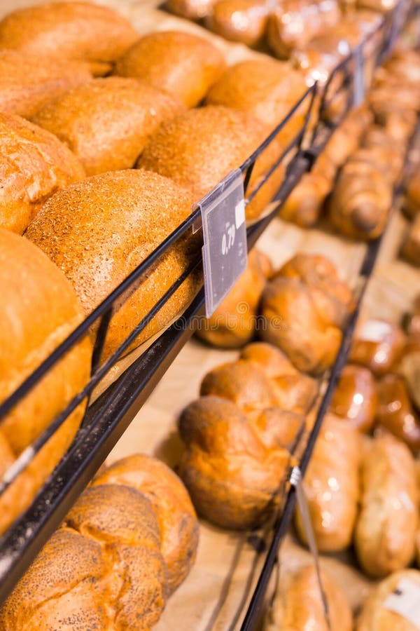 Fresh Wheat Breads on Bakery Counter Stock Photo - Image of brown ...
