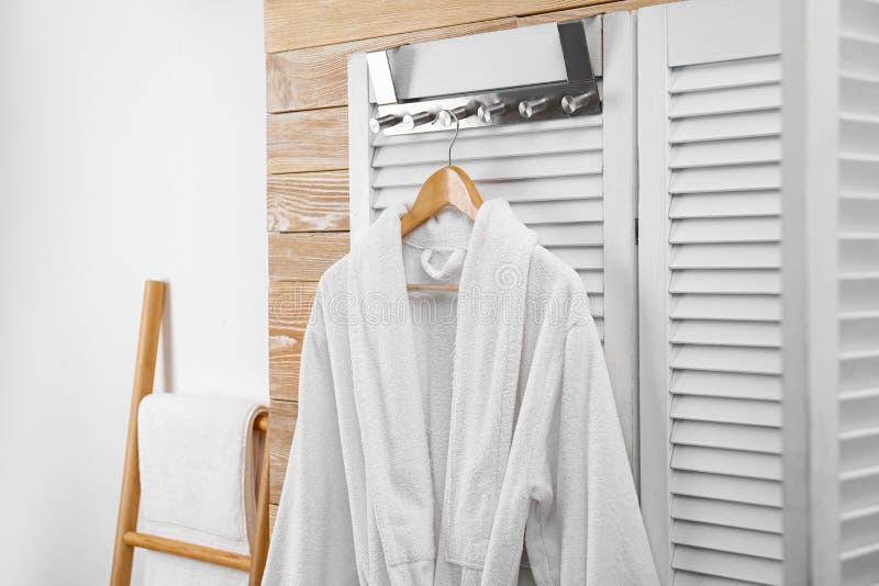 Fresh White Bathrobe Hanging on Folding Screen Stock Image - Image of ...