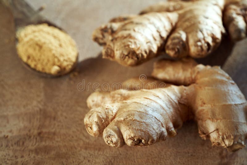 Fresh Whole Ginger Root, with Ginger Powder in the Background Stock ...