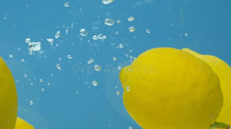 Fresh Whole Lemons Floating in Water Macro View Stock Video - Video of ...