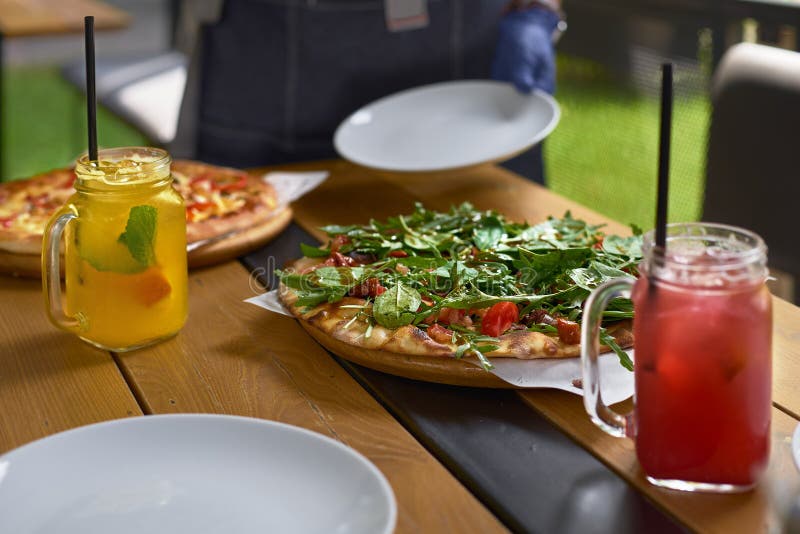 Fresh Whole Pizza and Lemonade on a Terrace Table in Italy Stock Photo ...