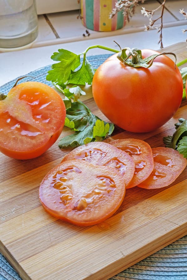 Fresh Whole and Sliced Tomatoes and Parsley Portrait Side Wide Stock ...