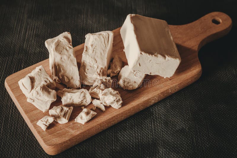 Fresh yeast in the kitchen stock photo. Image of chunks - 281700498