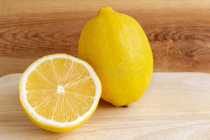Fresh Yellow Lemon and Slice of Lemon on a Wooden Table in the Kitchen ...