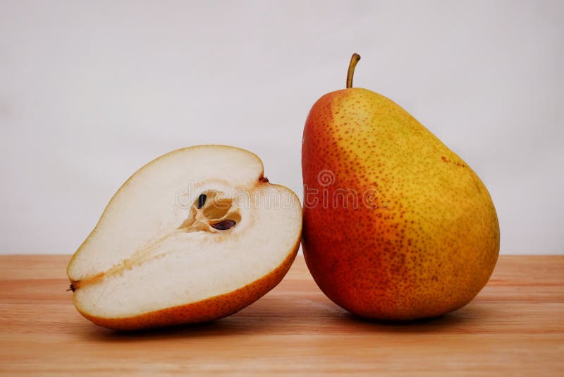 A Fresh Yellow and Red Pear on a Wooden Cutting Board Stock Image ...
