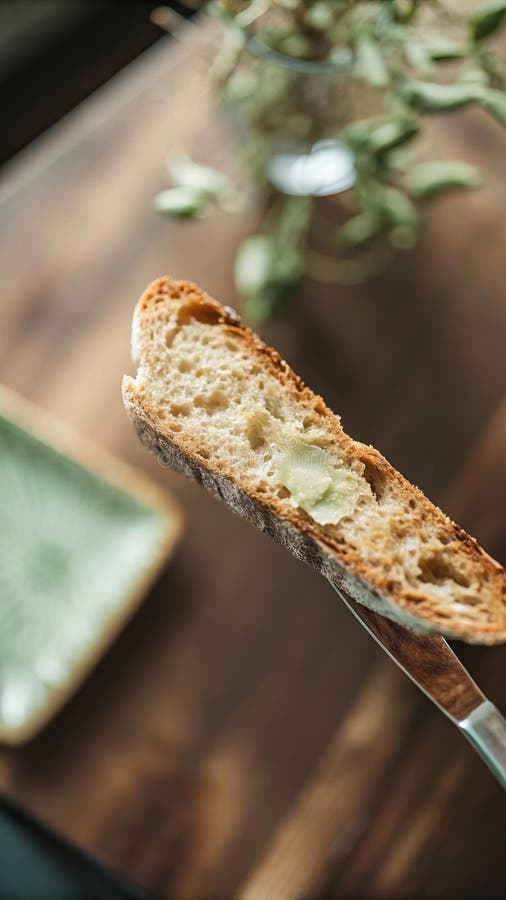 Freshly Baked Artisan Bread Slice with Melted Butter on Rustic Table ...
