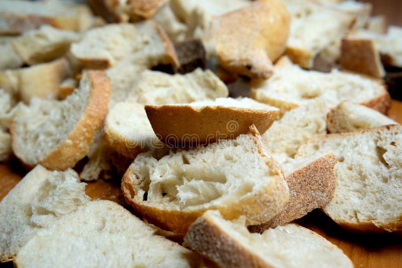 Freshly Baked Bread Pieces Scattered on a Wooden Surface Stock Image ...
