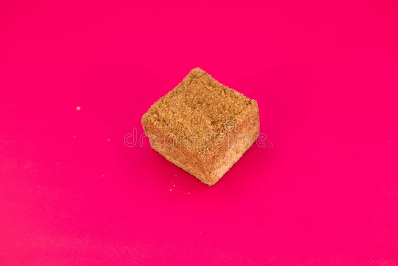 A Square Pastry on a Pink Surface with Some White Sugar Stock Photo ...