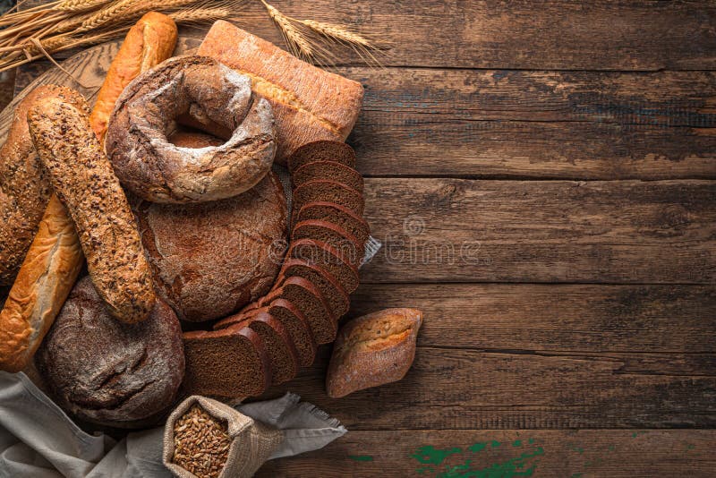 Freshly Baked Traditional Bread of Various Types on a Wooden Table ...