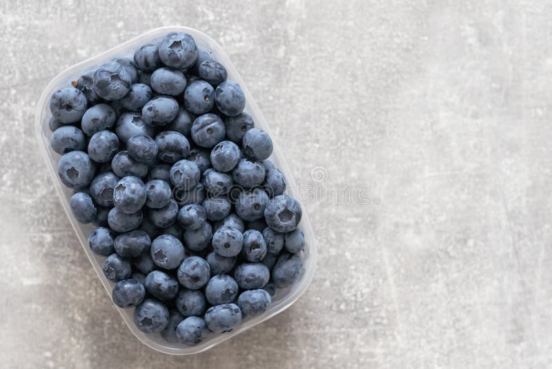 Freshly Blueberry in a Plastic Box Packed on a White Background. Space ...