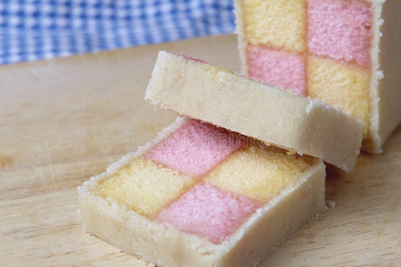 Freshly Cut Battenberg Cake Slices on Wooden Board with Dark Background ...