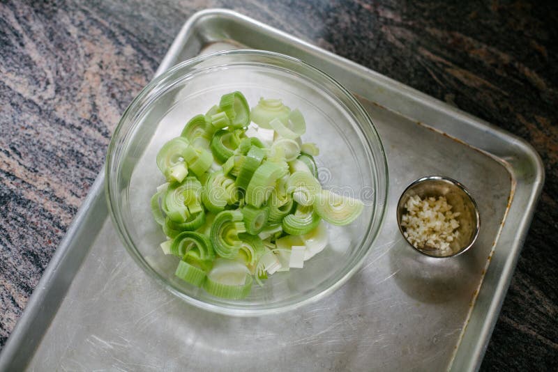 Freshly Cut Leeks in a Glass Bowl on Marble Surface Stock Photo - Image ...