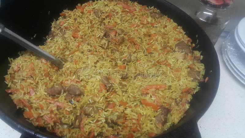 Fried Pilaf or Pilau Rice Dish Served in a Red Melamine Plate on a Red ...