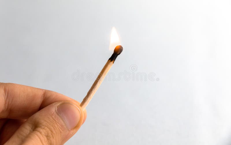 Freshly Lit Match in the Hand of a Teenager on a Plain White Background ...