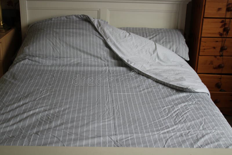 Freshly made bed stock image. Image of grey, bedding - 181398225