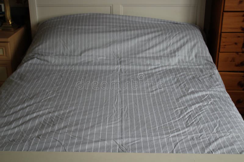 Freshly made bed stock photo. Image of duvet, bedding - 181398248