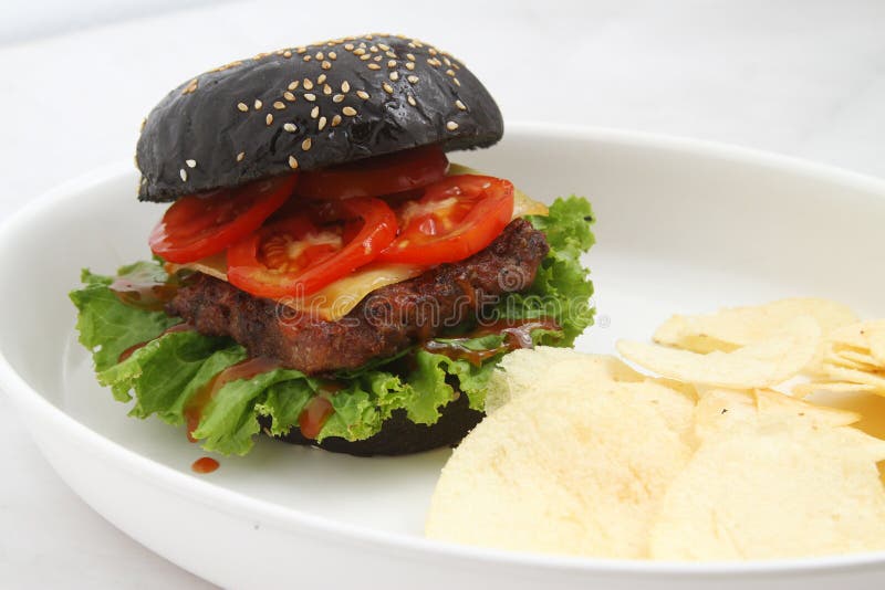 Freshly Made Hamburger with Cheese and Vegetables in a Black Colored ...
