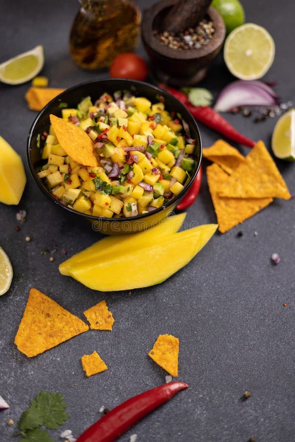 Freshly Made Mango Salsa in a Black Ceramic Bowl, Nacho Chips and ...