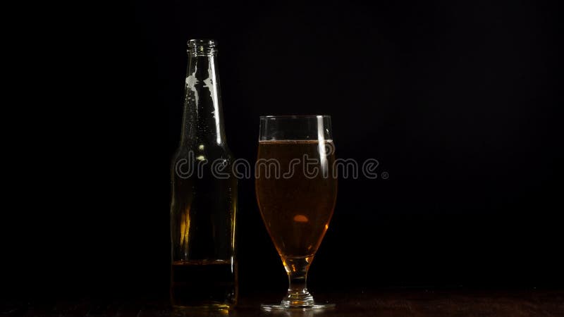 A Freshly Opened Beer Bottle with Condensation and Bubbles Rising ...