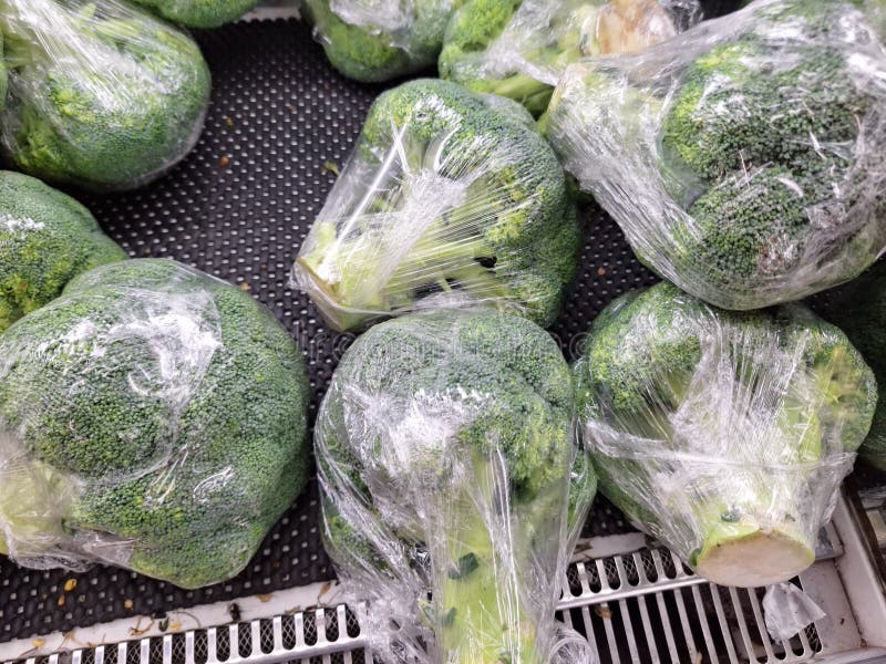 Freshly Packaged Broccoli Heads on Display at a Grocery Store Stock ...