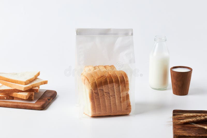 Freshly Packaged Sliced Bread with Milk and Wheat on a Clean Tabletop ...