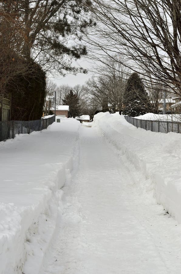 Freshly Plowed Sidewalk with Deep Snow on All Sides Stock Photo - Image ...