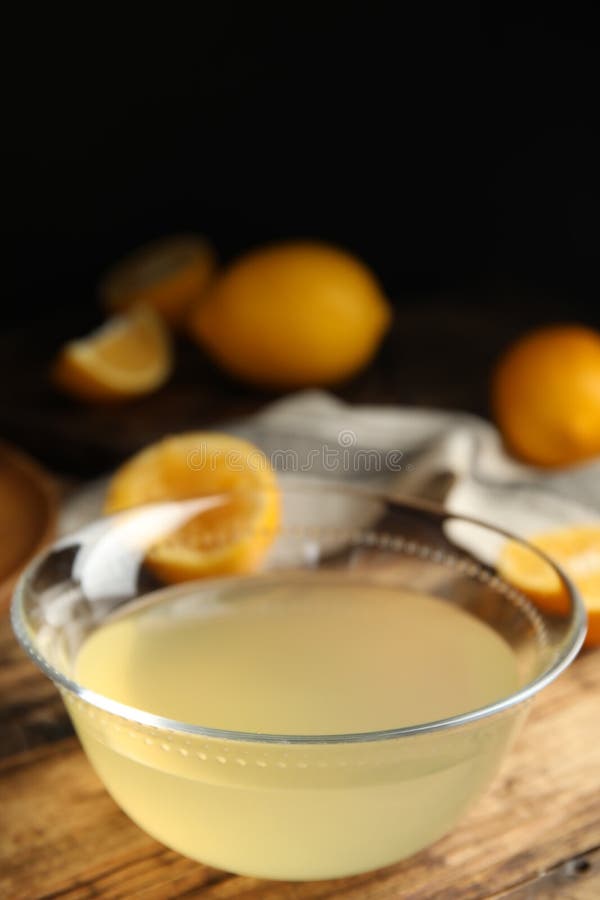 Freshly Squeezed Lemon Juice in Glass Bowl on Wooden Table Stock Image ...