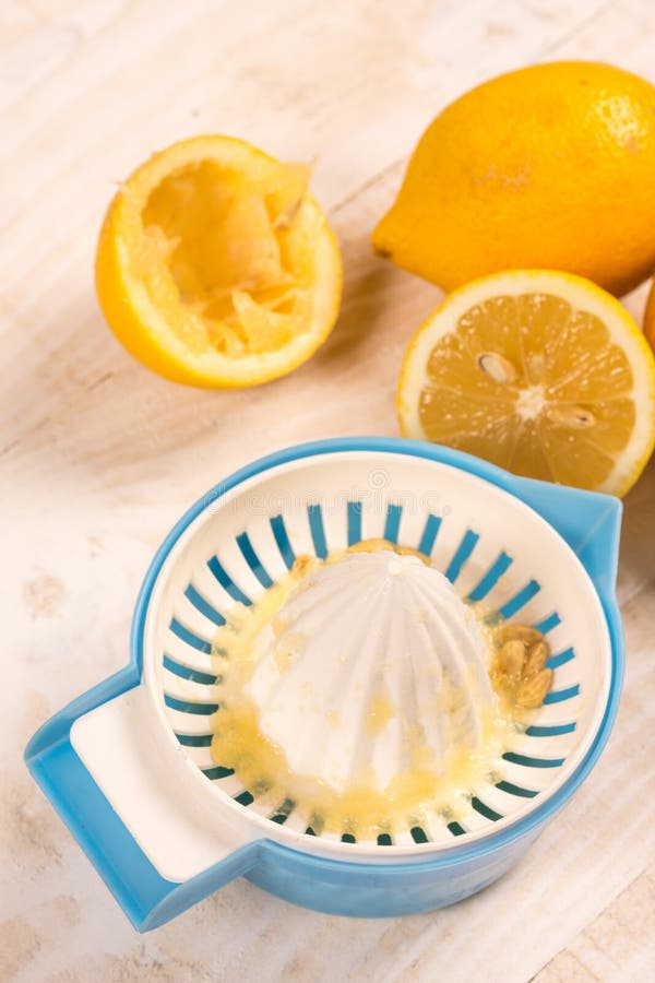 Freshly Squeezed Lemon with Strainer Above Wooden Background Stock ...