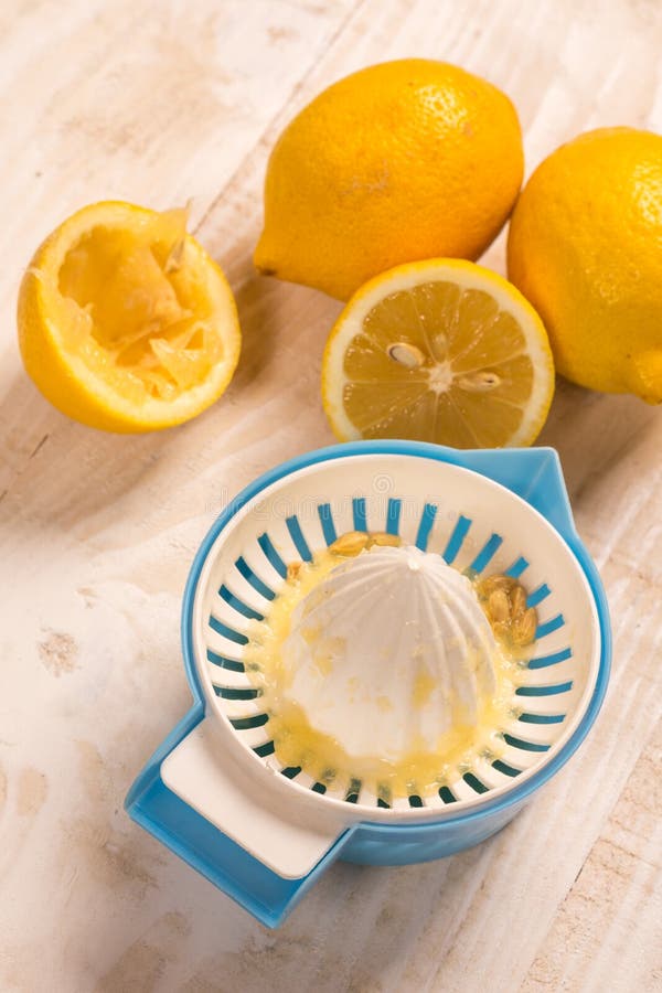 Freshly Squeezed Lemon with Strainer Above Wooden Background Stock ...