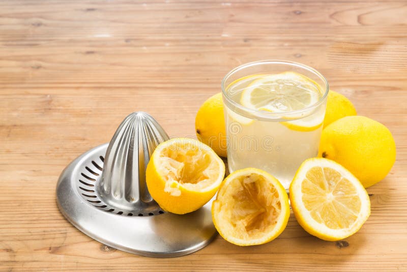 Freshly Squeezed Organic Lemon Juice with Glass and Squeezer. Stock ...