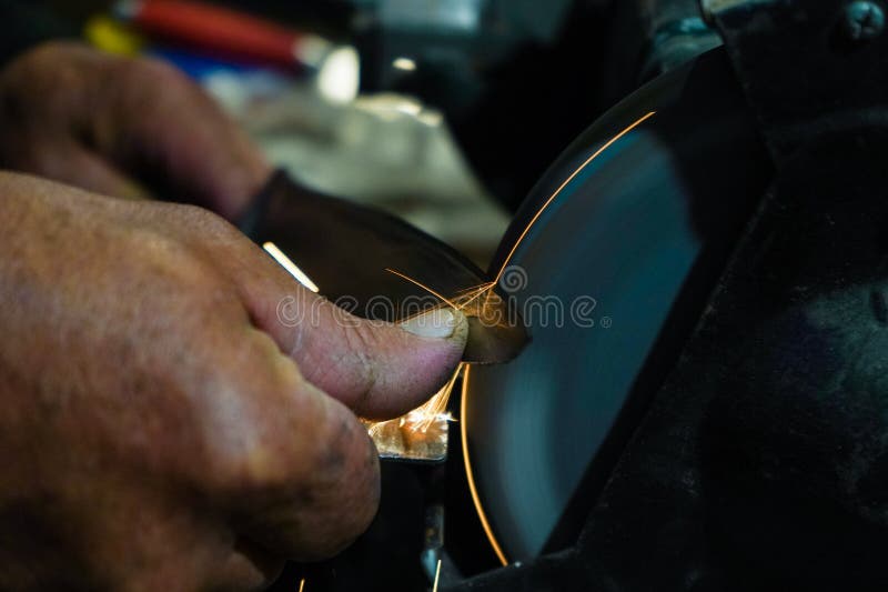 The Friction Creates Bright Sparks. the Dim Background of the Workshop ...